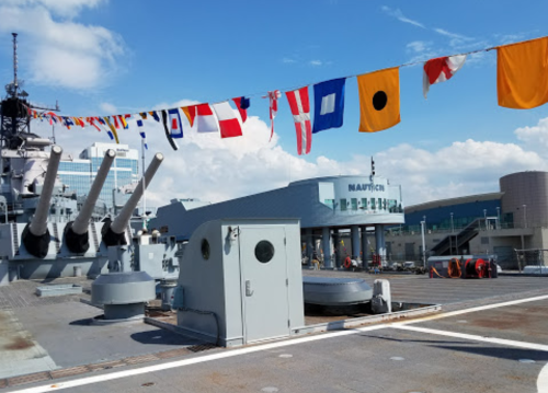 A naval ship deck adorned with colorful signal flags, featuring large ...