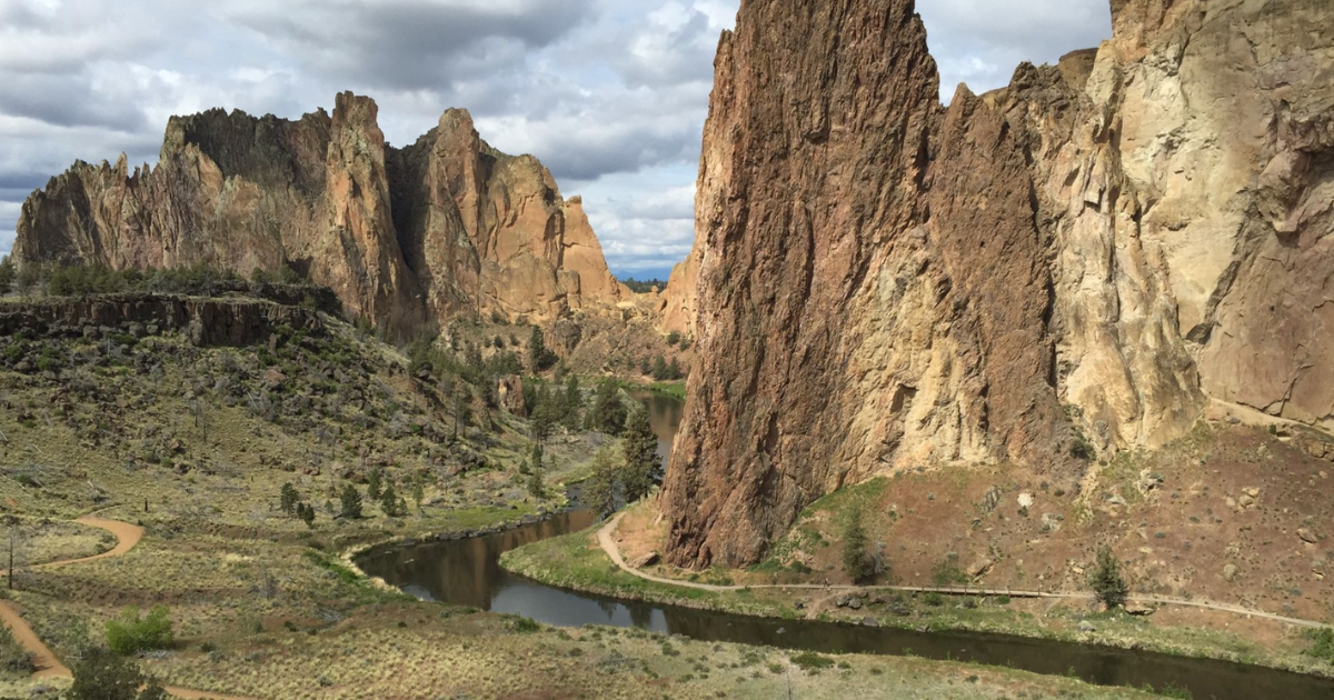 The Oregon Trail With A River And Towering Rock Formations That You ...